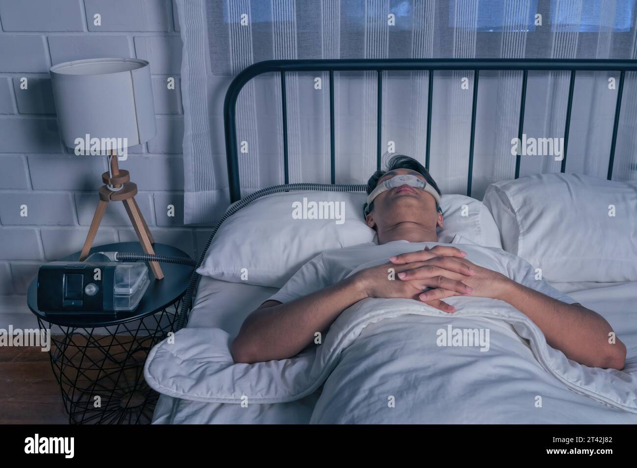 Happy and healthy Asian man with CPAP machine on side table wearing ...