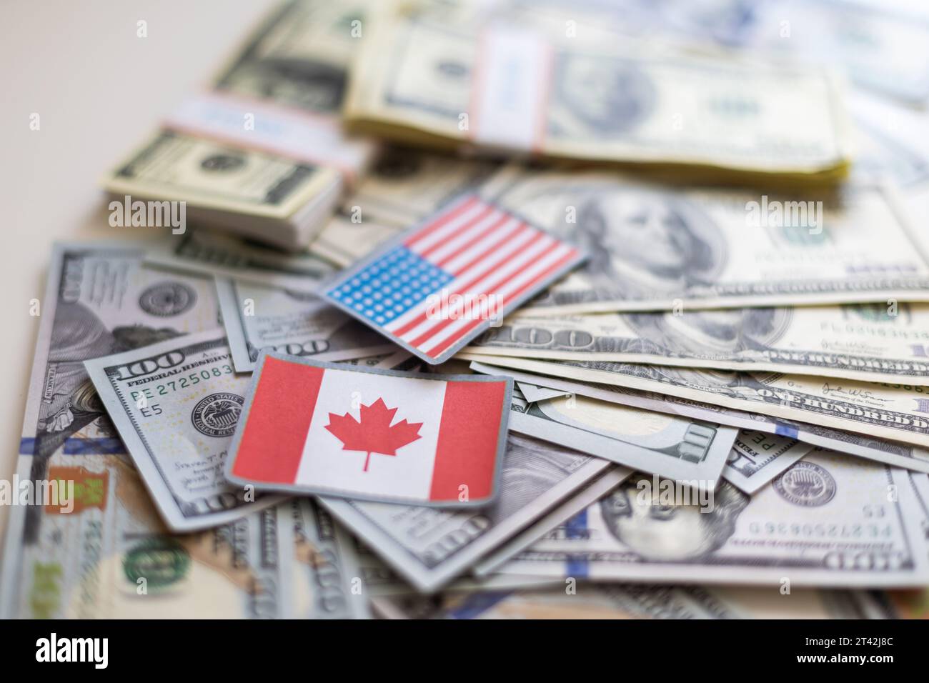 us and canadian flag on a us dollar background Stock Photo - Alamy