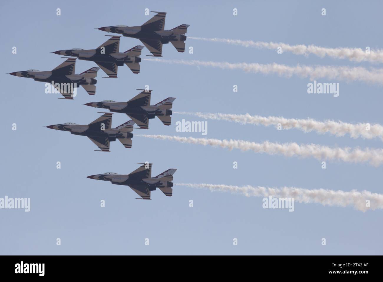 Six fighter jets are flying in formation and producing long smoke ...