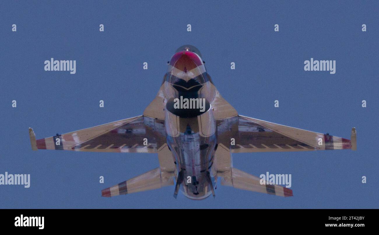 A military fighter jet soaring through the sky with its wings spread in ...