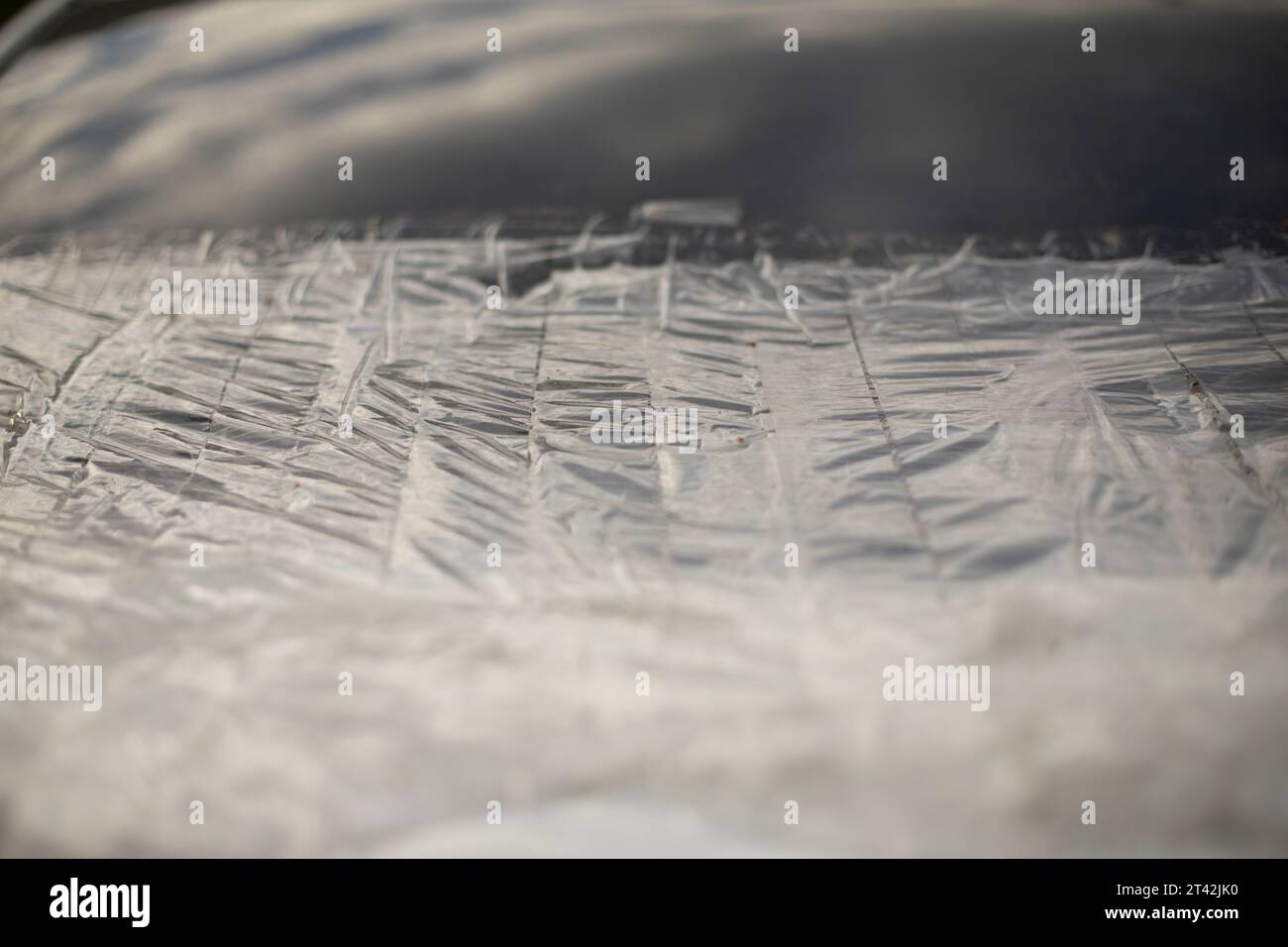 Adhesive tape on car. Sealed area on material. Sealed broken glass ...