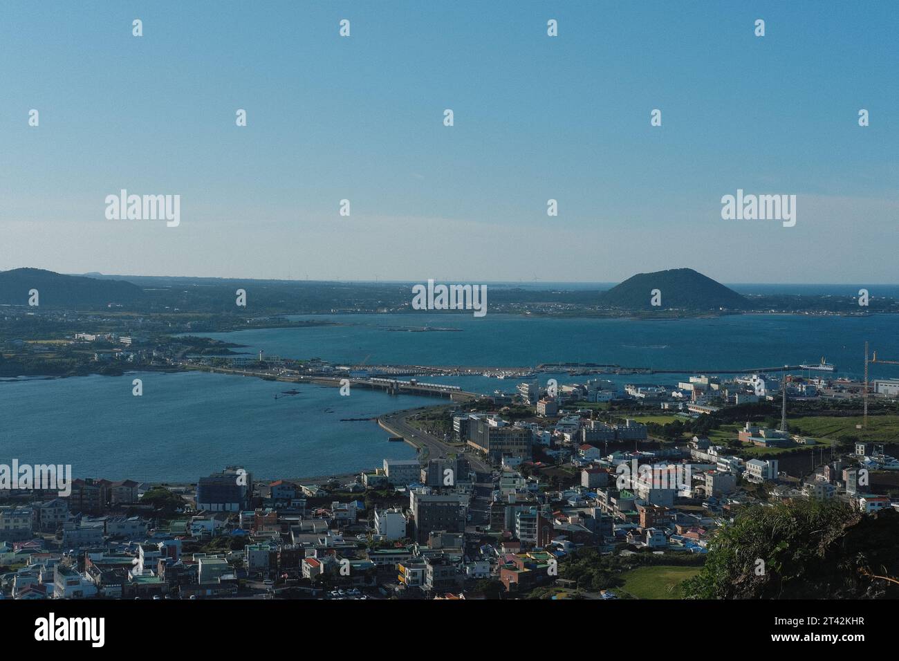 A scenic view of Jeju Island, South Korea, featuring a few buildings ...