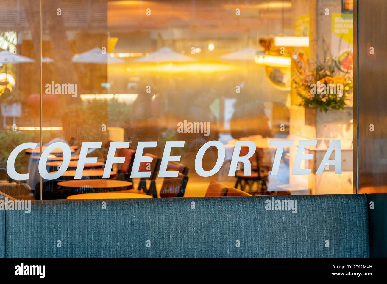 Coffee or tea text printed on the window of a modern drink shop ...