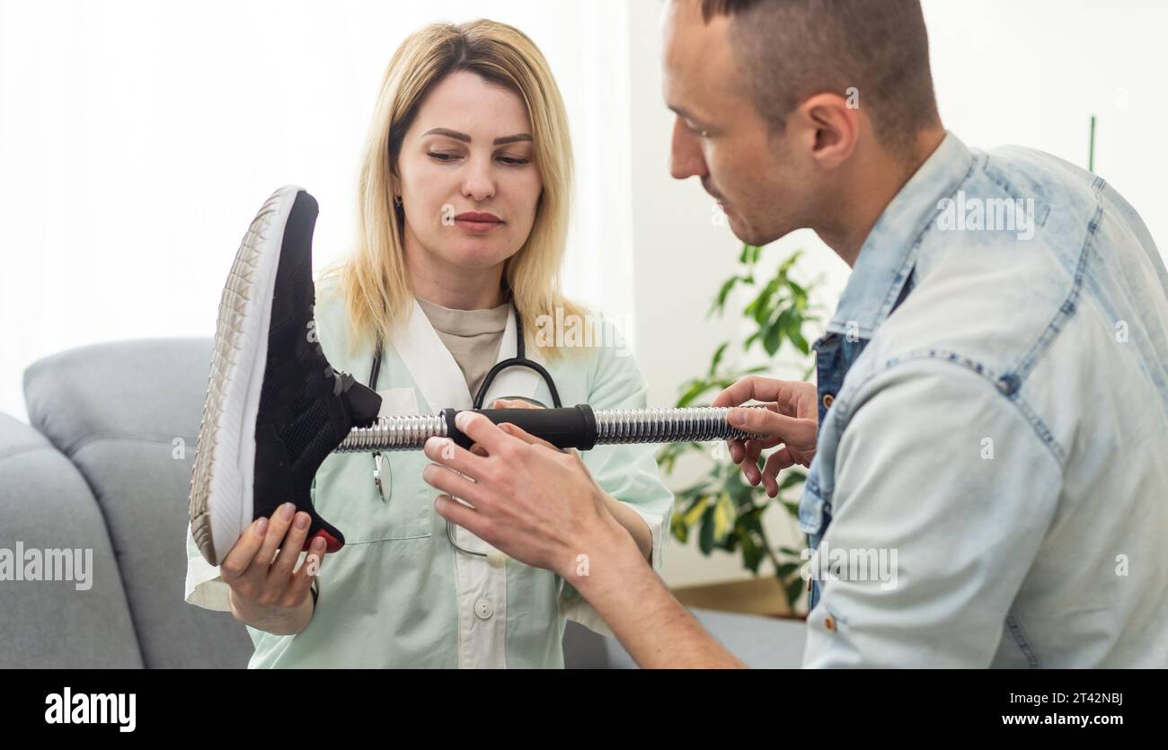 Modern Hospital Physical Therapy: Doctor Uses Tablet Computer, Helps ...