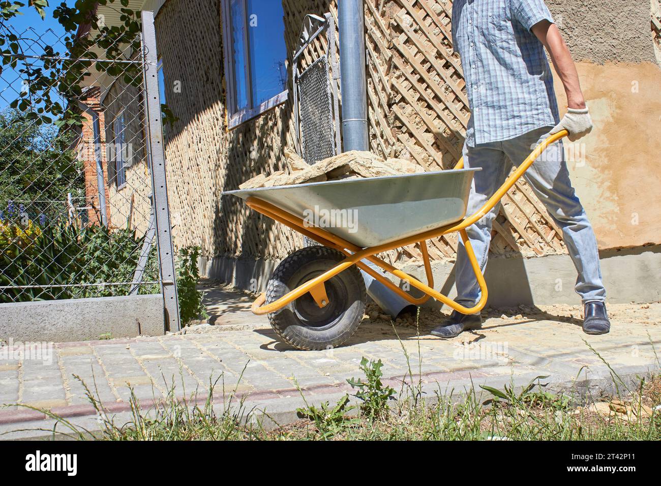 work on the construction of the wheelbarrow removal of an old plaster ...