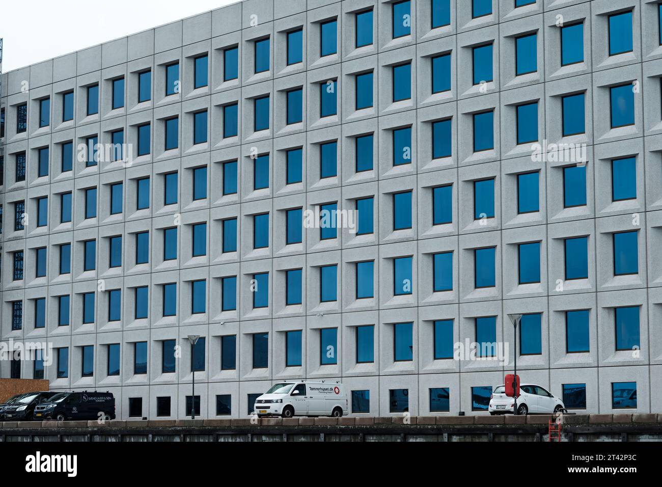 An image of an office building featuring a large clock on the facade ...