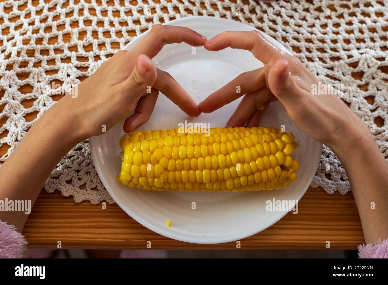 make hearts out of your fingers in front of the corn Stock Photo - Alamy