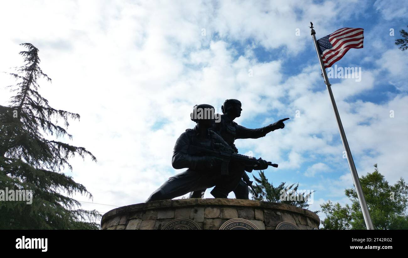 An ornate bronze statue stands atop a solid stone platform Stock Photo ...