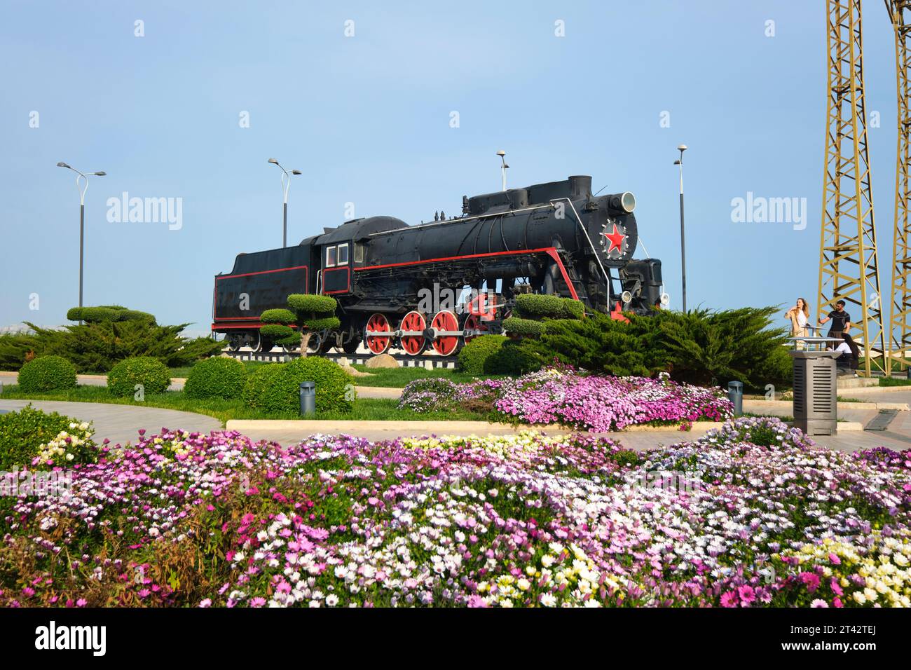 An old black and red steam train on display. Behind the Stone Chronicle ...