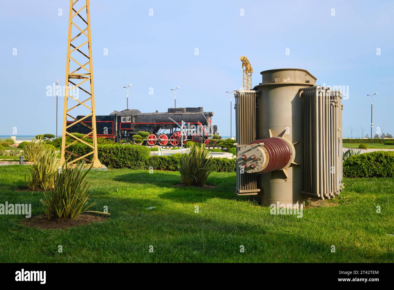 An old black and red steam train on display. Behind the Stone Chronicle ...