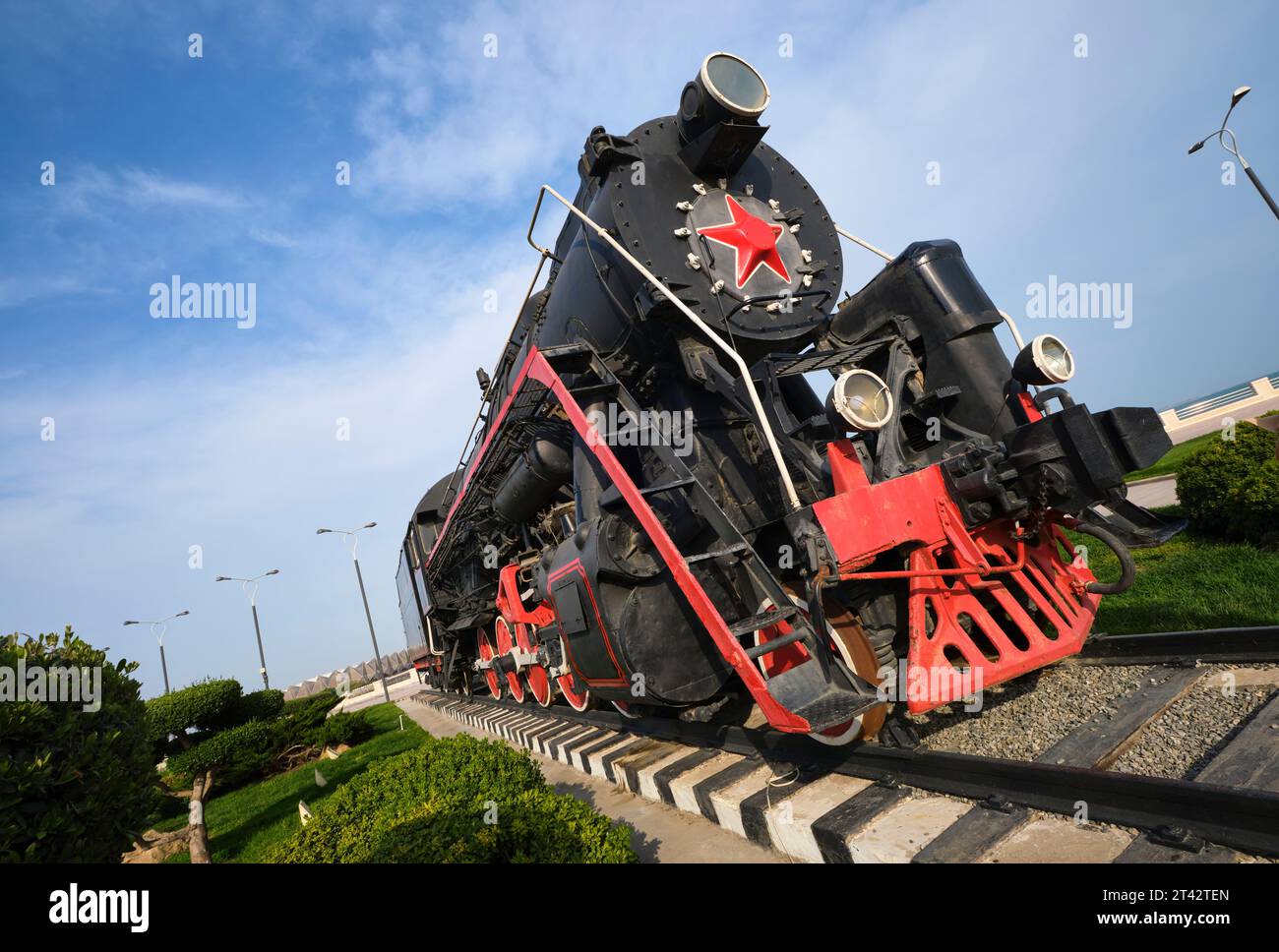 An old black and red steam train on display. Behind the Stone Chronicle ...