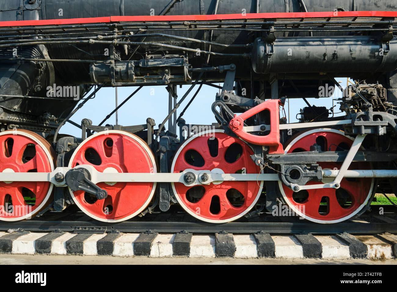 An old black and red steam train on display. Behind the Stone Chronicle ...