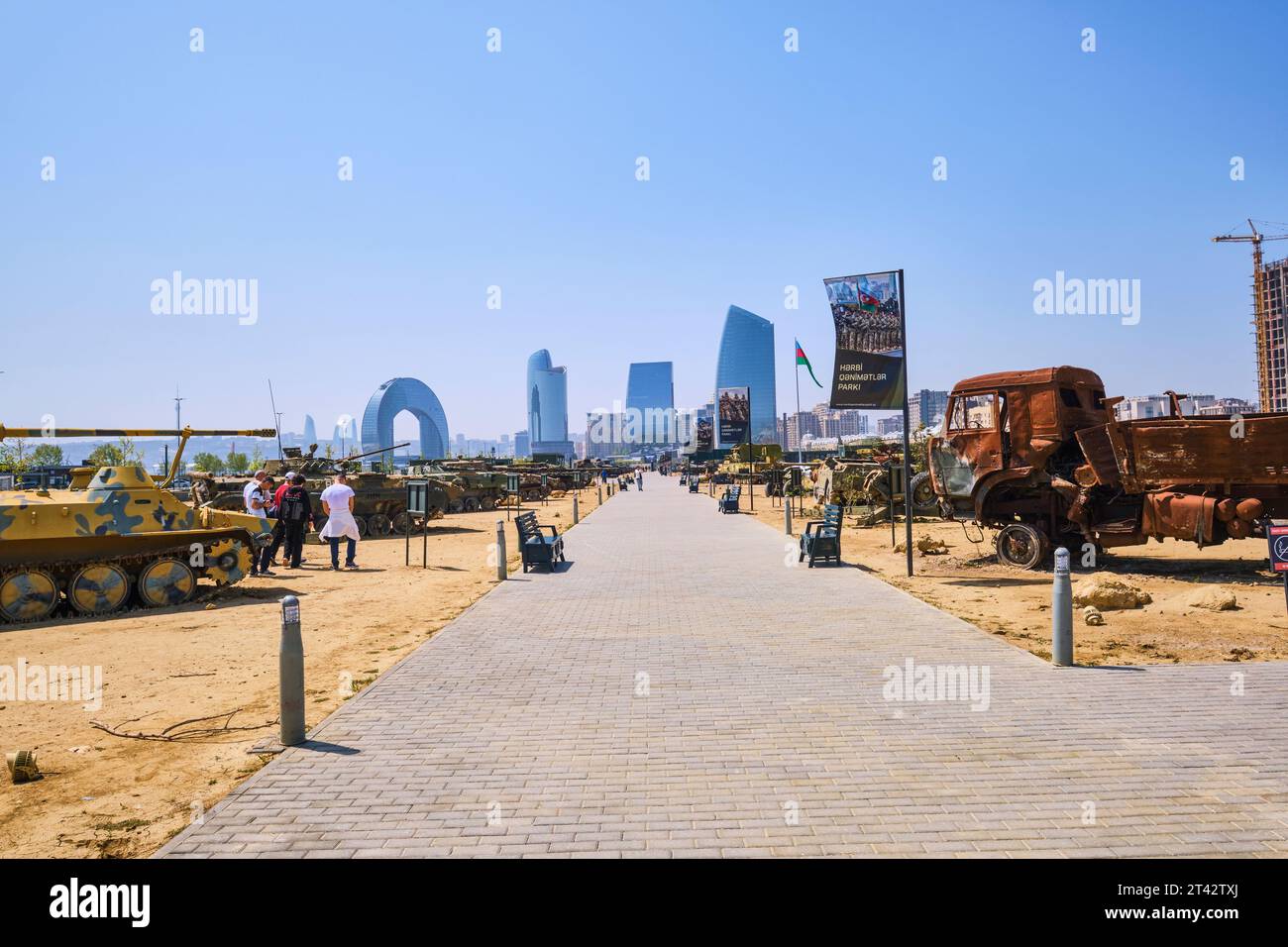 Various people visiting, walking in the park with the Baku skyline in ...