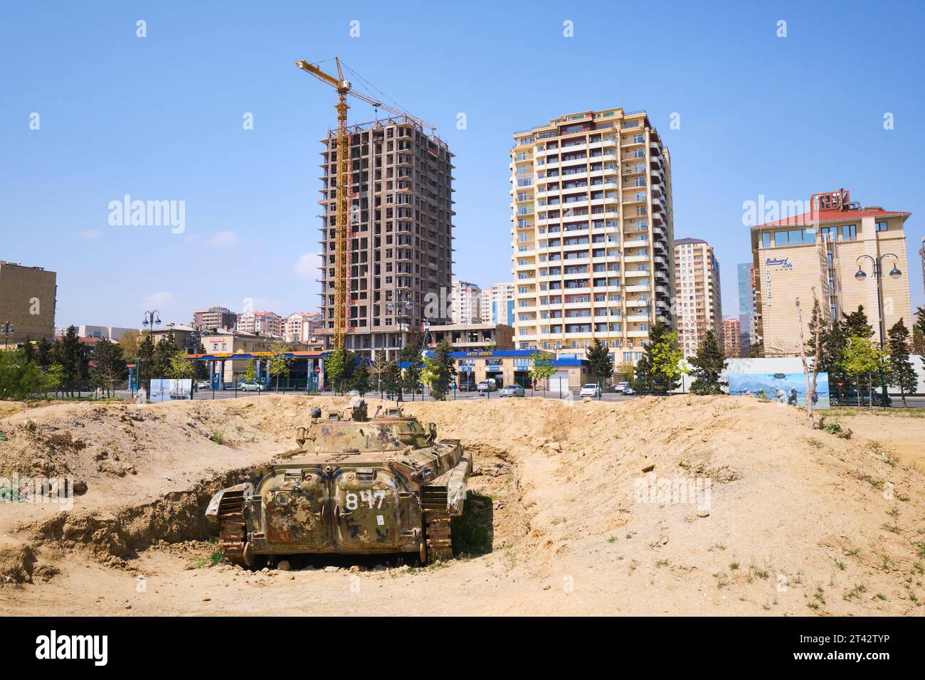 A tank, digging in a position with apartment contruction in the ...