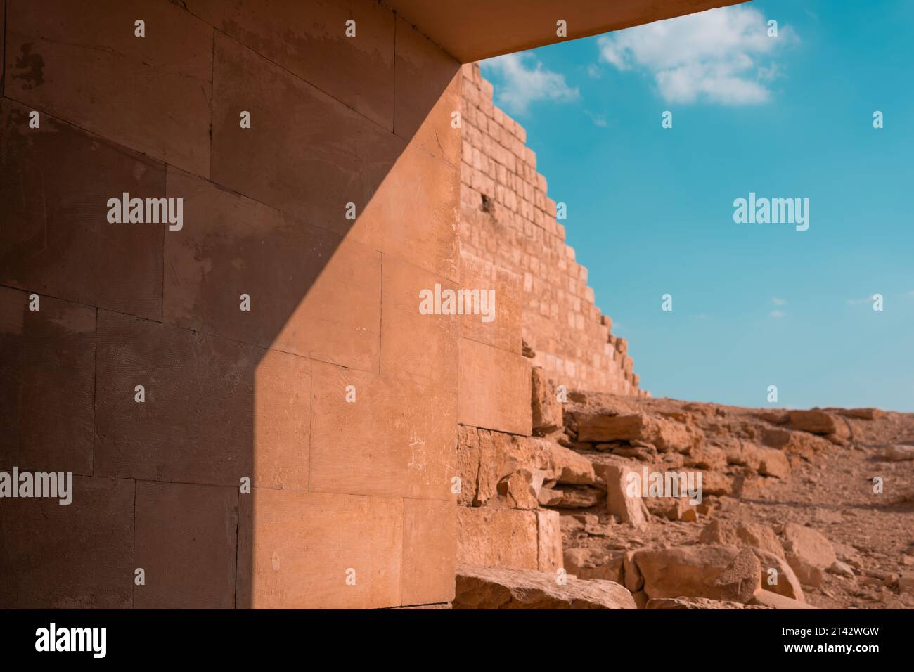 A view of the Step Pyramid rising amidst the desert terrain of Saqqara ...