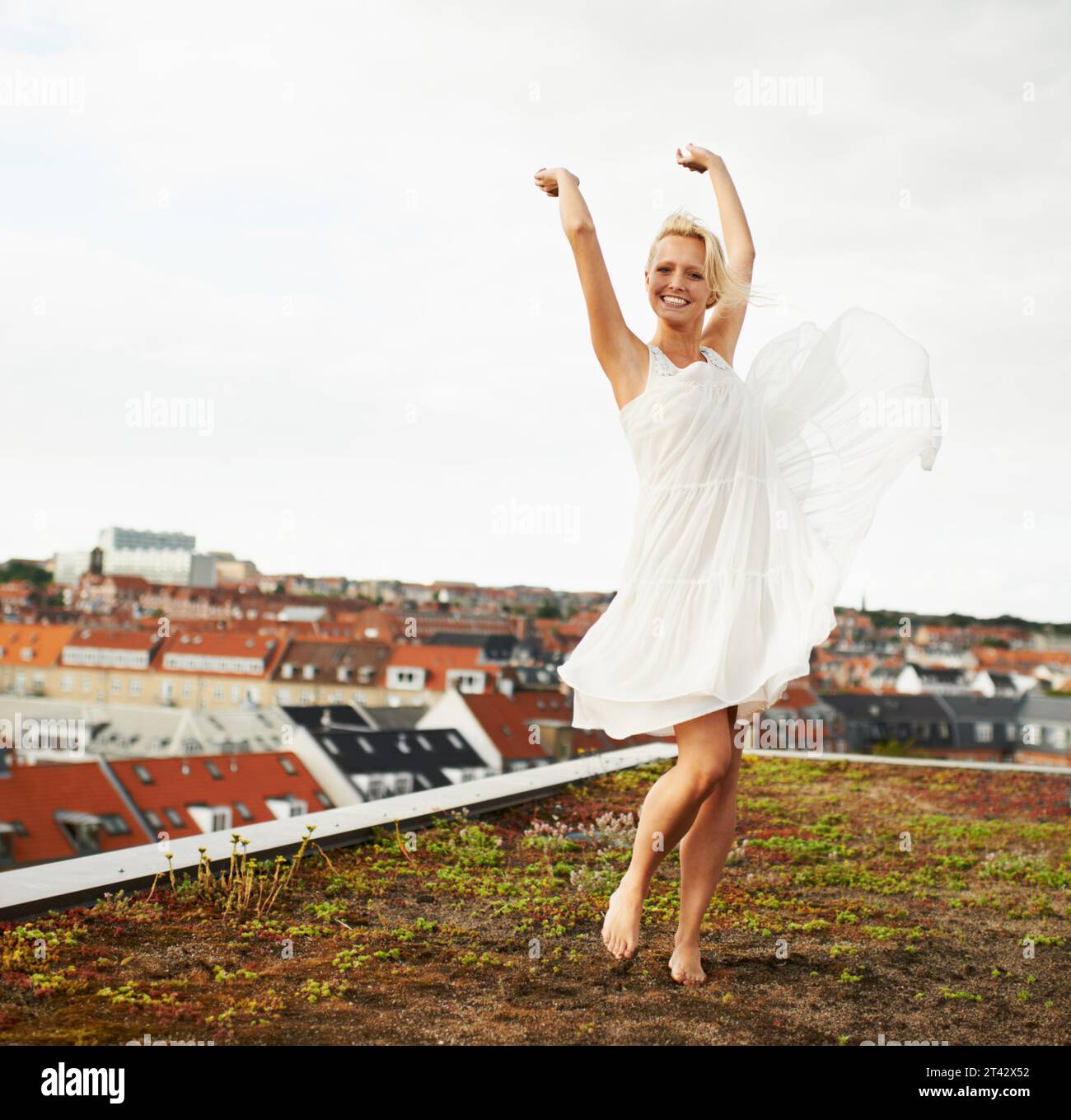 Woman, happiness and dancing on rooftop, carefree and outdoor with ...