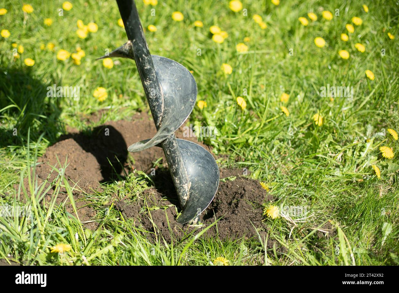 Drill for digging up earth. Planting tool. Excavated soil. Drill bit ...