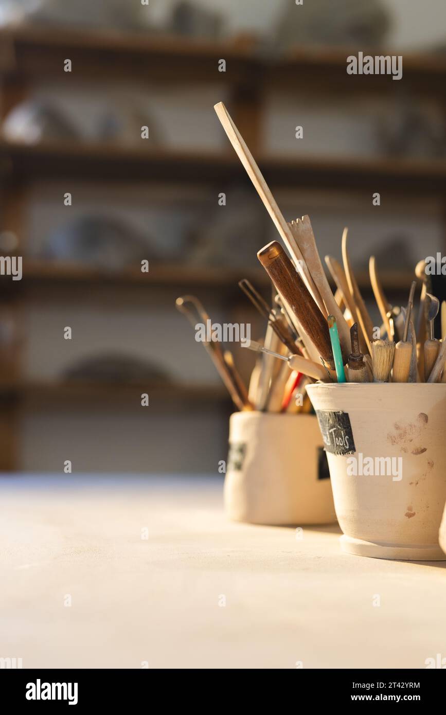 Close up of pottery tools in clay cups in pottery studio Stock Photo ...