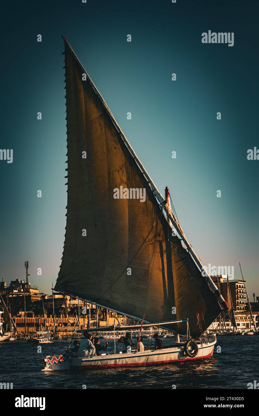 Traditional felucca sailboat graces the Nile River against Luxor's ...