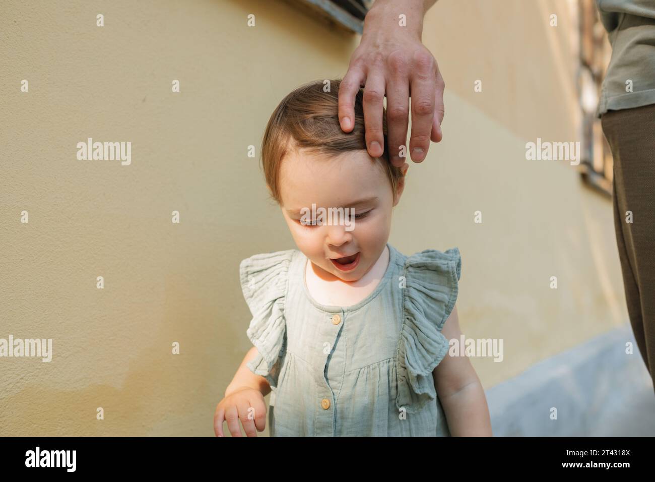 Father touching daughters head hi-res stock photography and images - Alamy