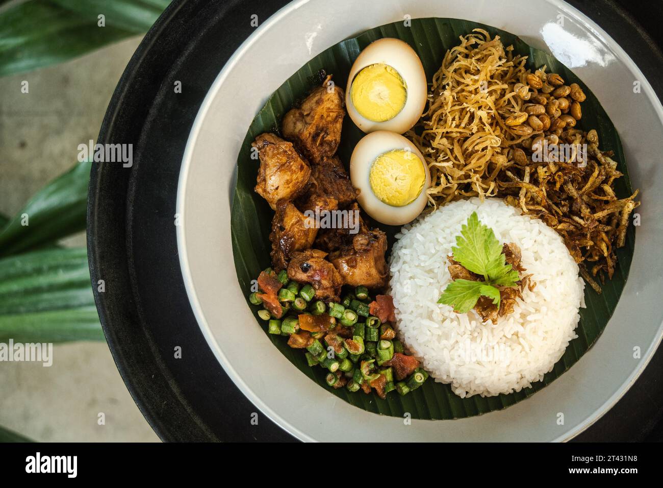 Overhead view of a traditional breakfast of rice, egg, shoestring fries ...