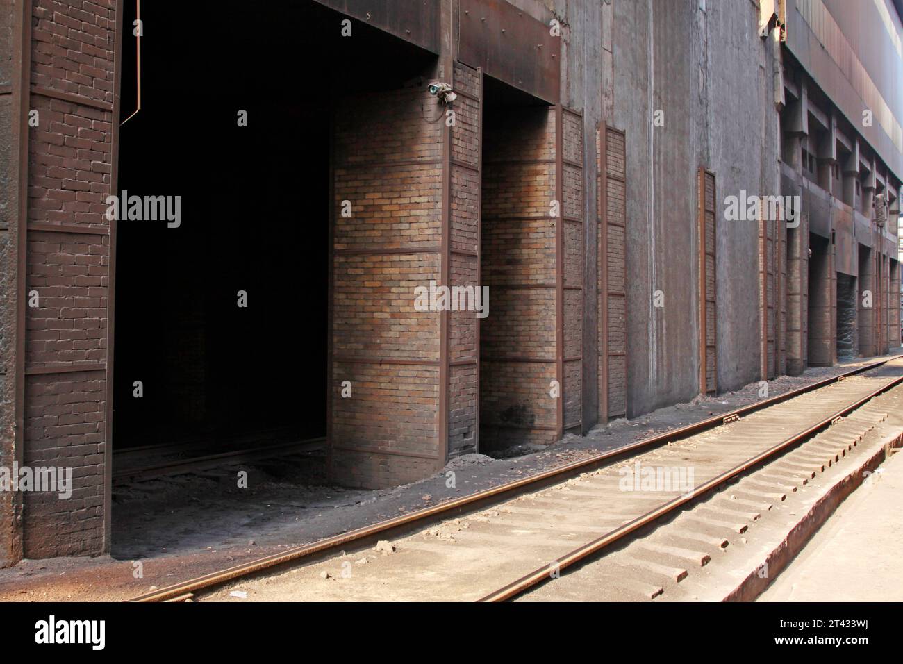 Industrial building and railway vehicles in a factory, closeup of photo ...