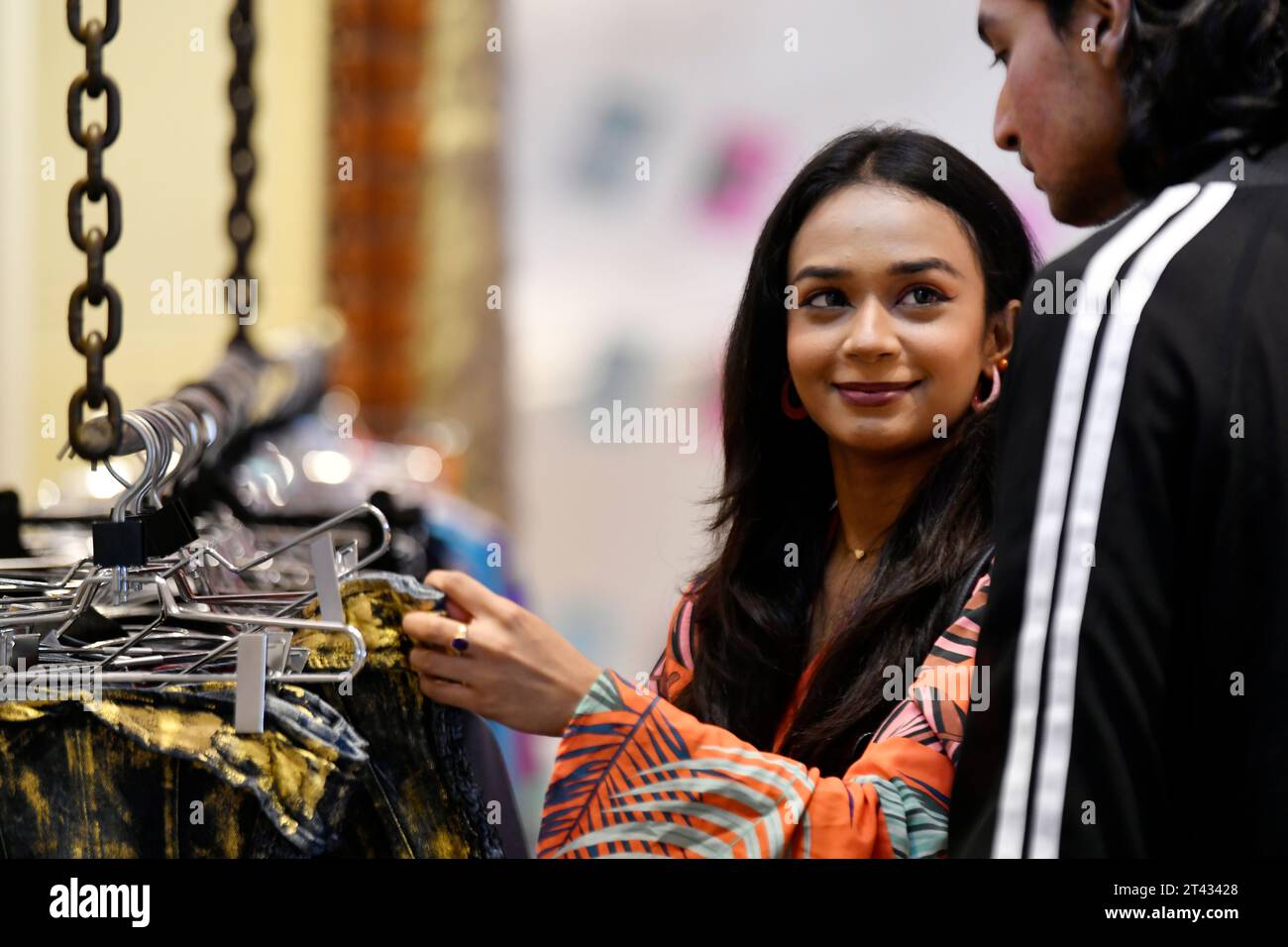 Dhaka, Bangladesh. 27th Oct, 2023. A visitor looks at modern clothes at a shop during the ARKA ...