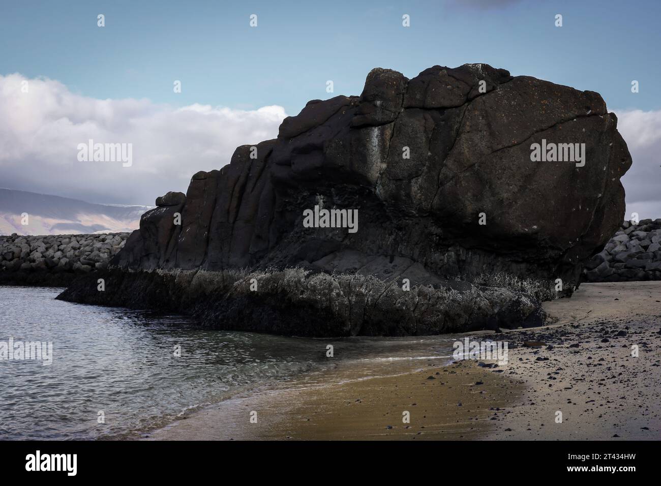 Big black volcanic rock on Skarfaklettur beach in Reykjavik, Iceland ...
