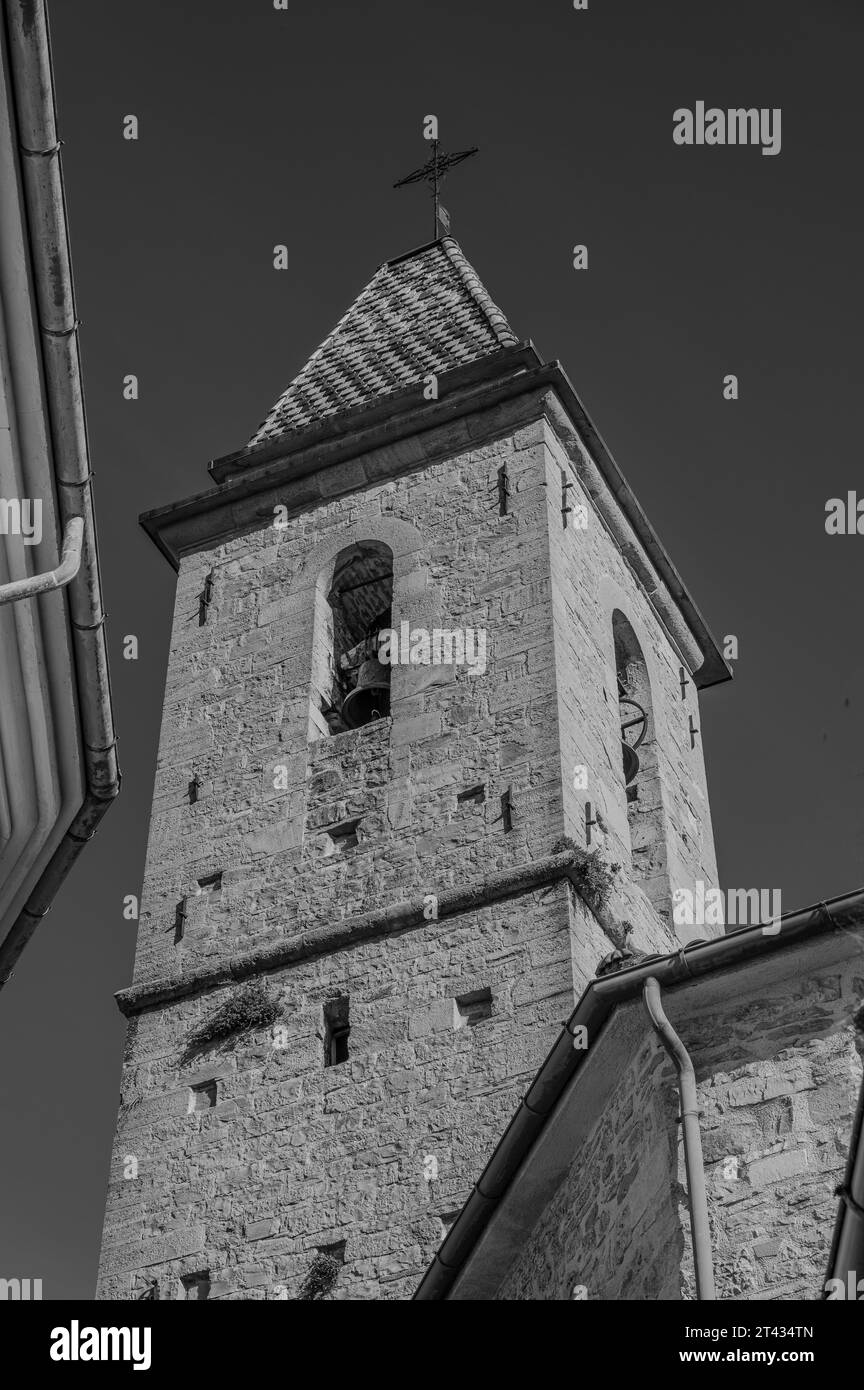 The façade is simple, in stone ashlars, with a portal decorated with a ...