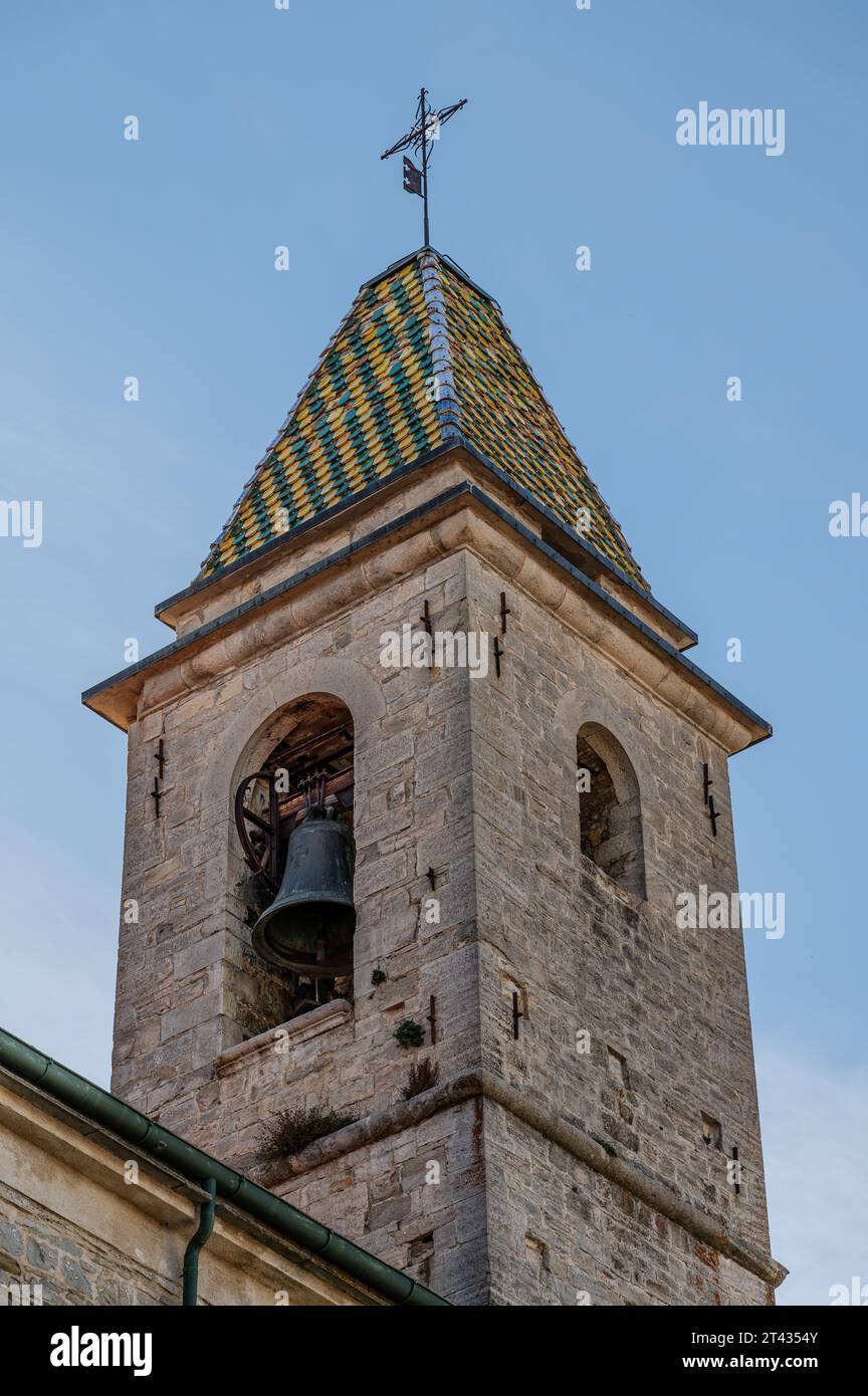 The façade is simple, in stone ashlars, with a portal decorated with a ...