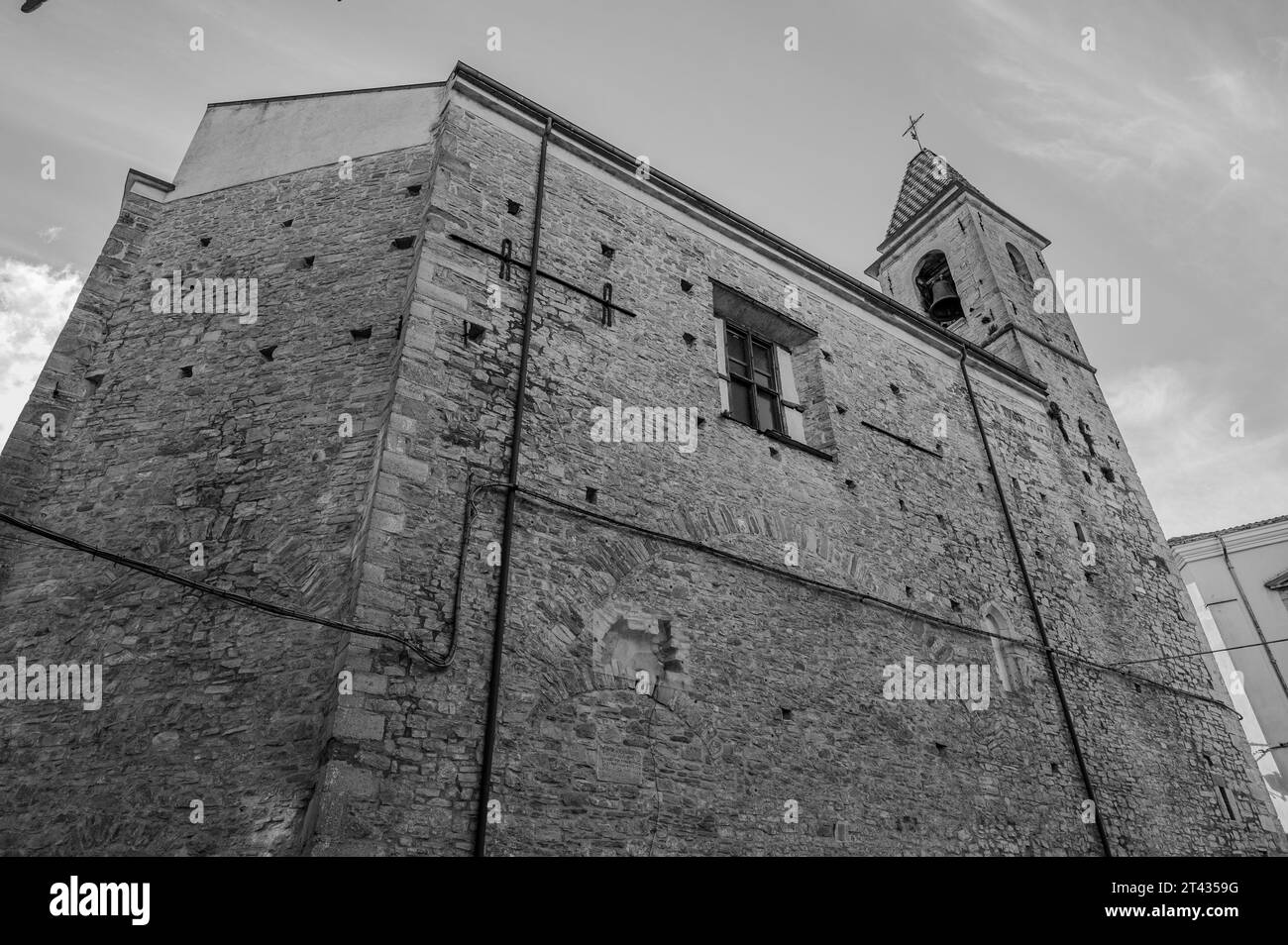 The façade is simple, in stone ashlars, with a portal decorated with a ...
