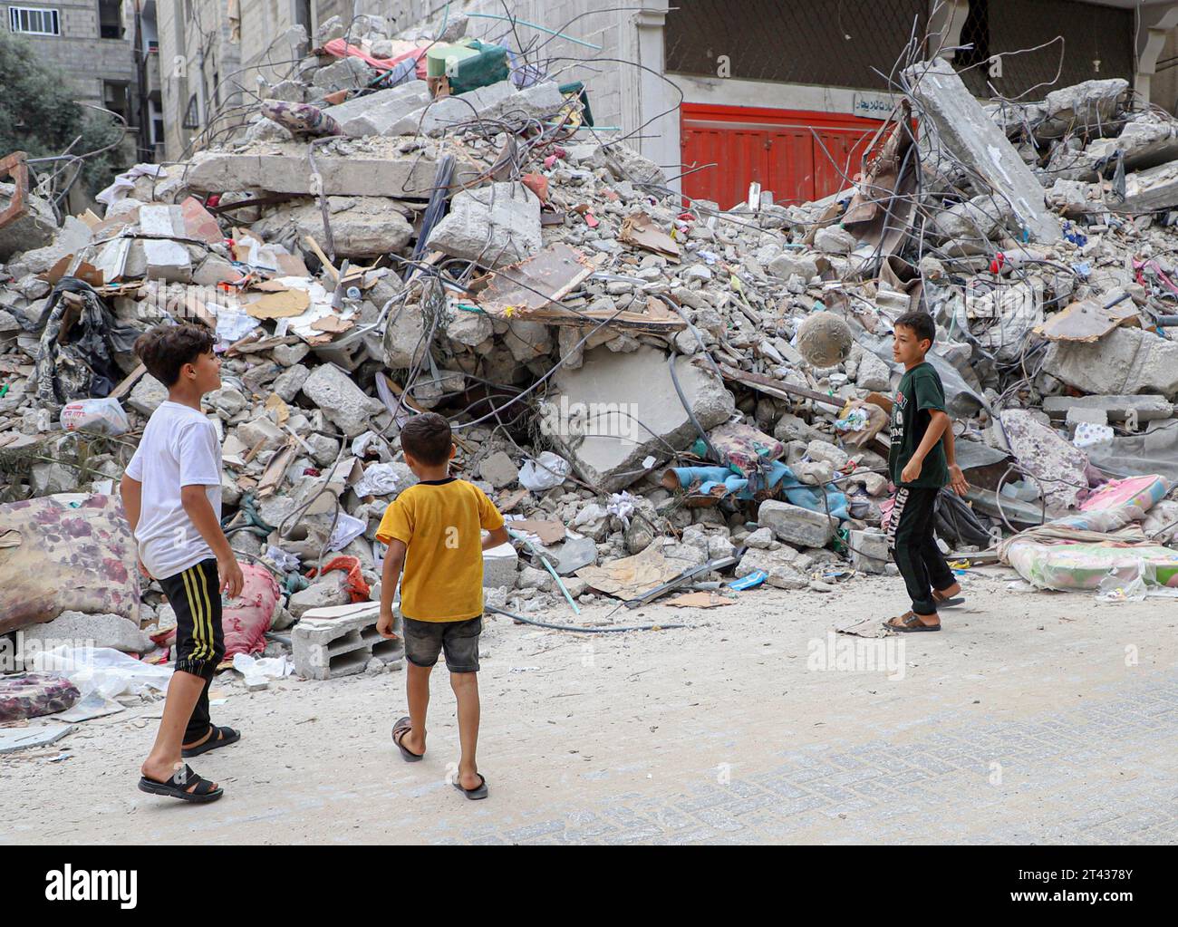 Gaza. 27th Oct, 2023. Palestinian children play football beside ruins ...