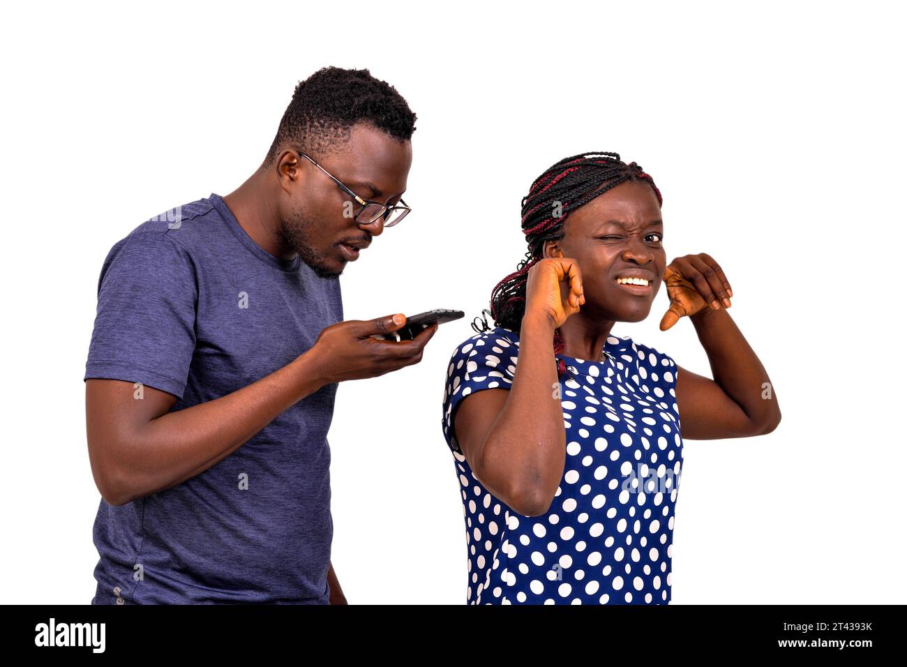 portrait of a jealous young man checking the messages on his girlfriend ...