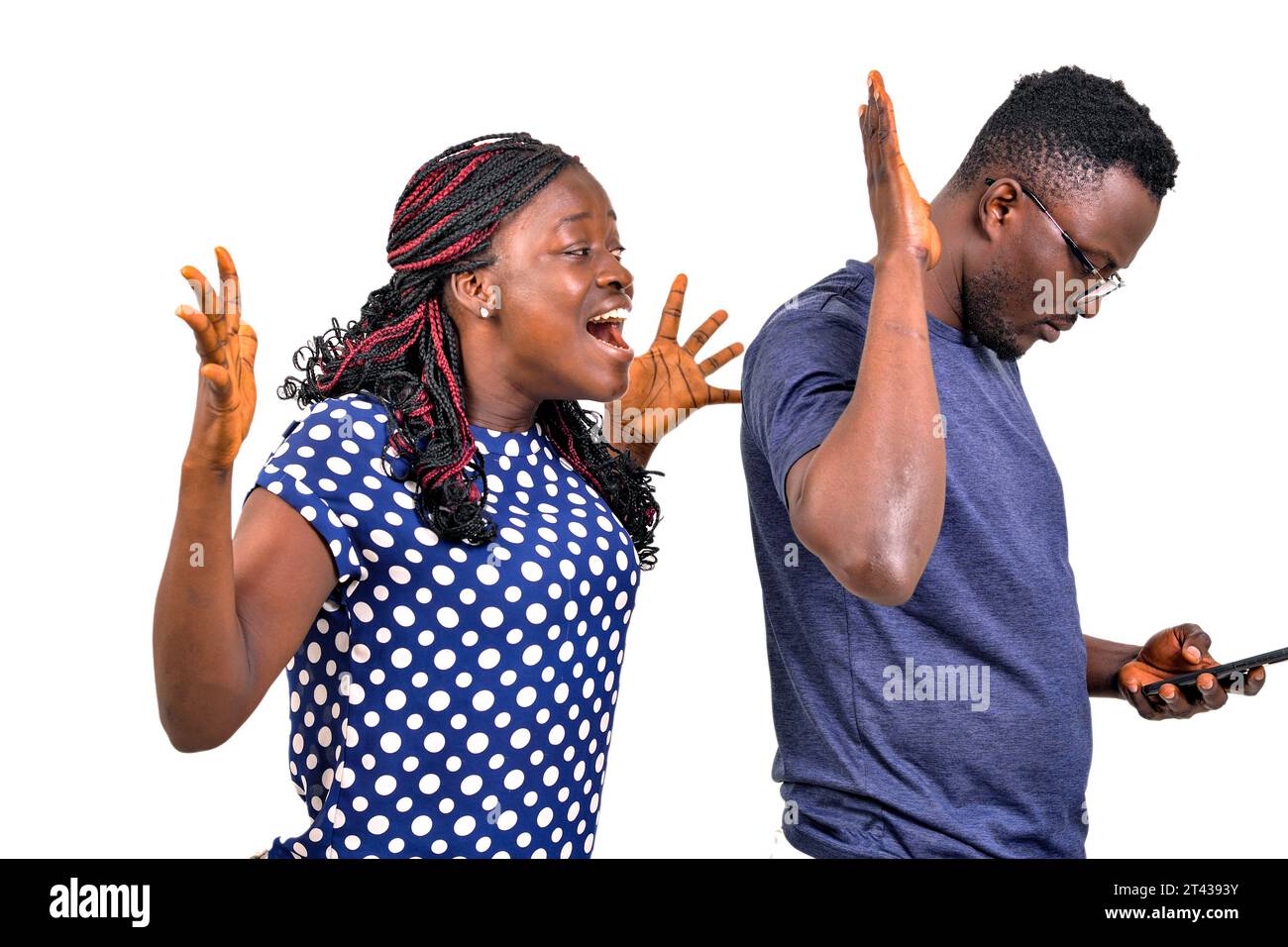 young man chatting on his cell phone while his angry girlfriend scream ...