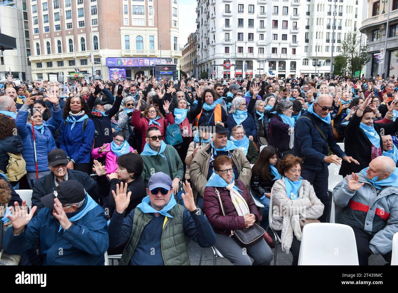 Dozens of people clapping in sign language during a rally of deaf ...