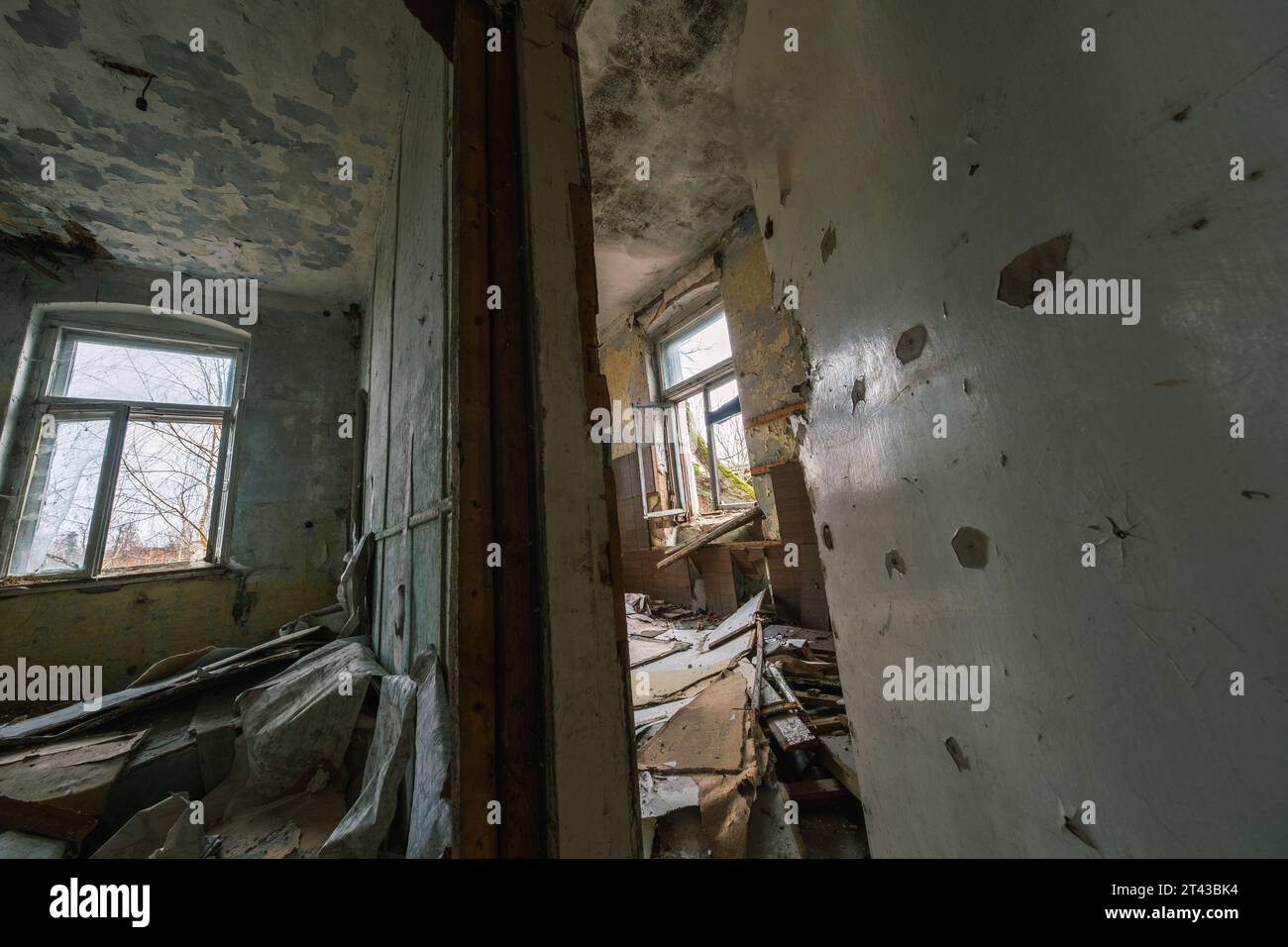 From above interior of shabby abandoned room with peeling painted walls ...