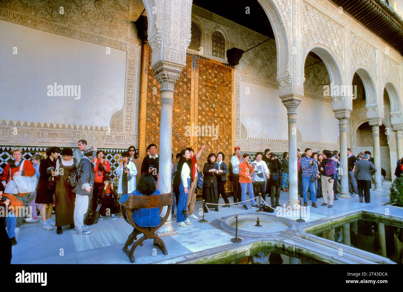 GRANADA, SPAIN-JULY 27,2022: Group of tourists at the famous Alhambra Palace. This is an Unesco ...