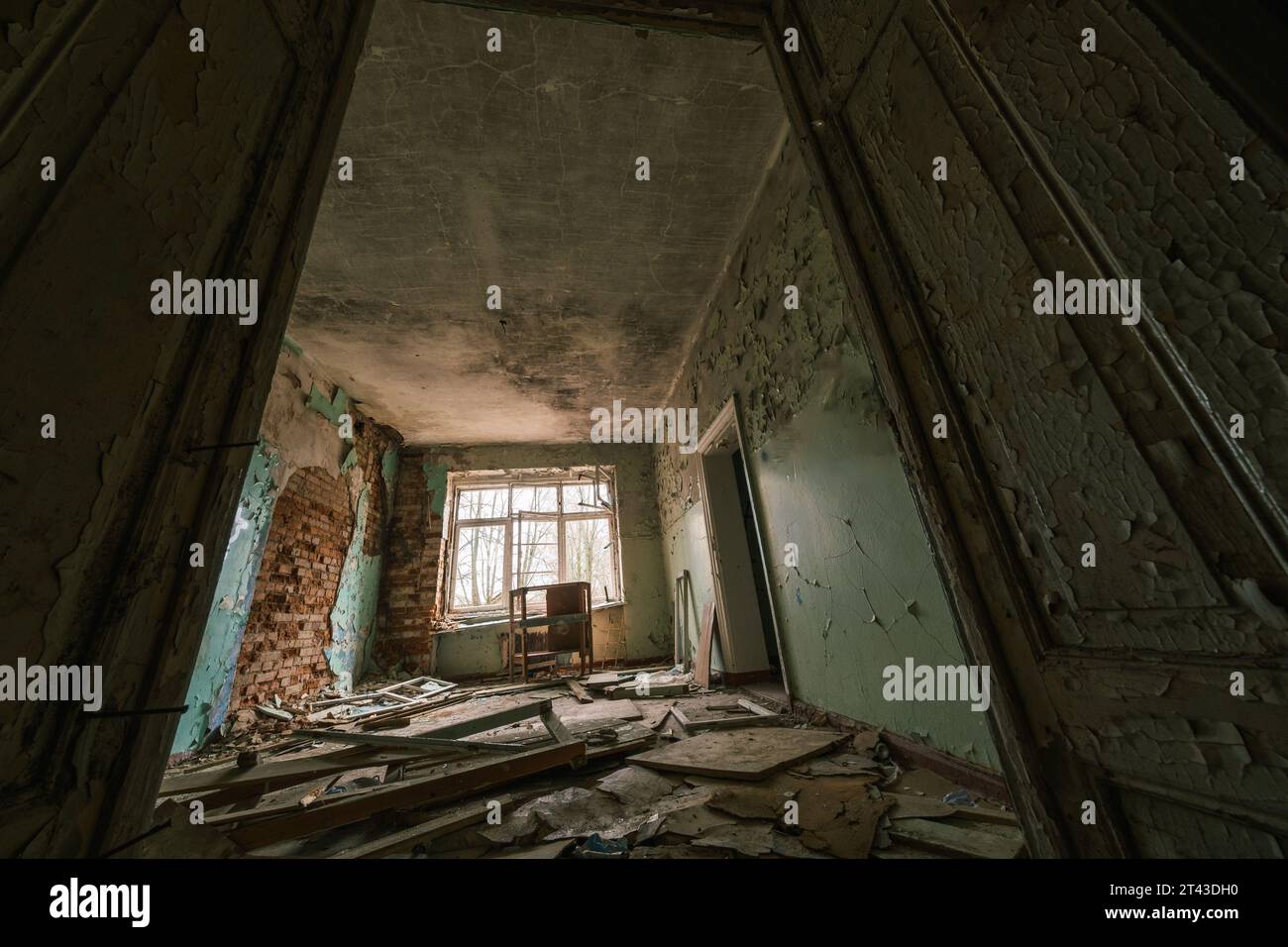 Hall entrance from dirty doorway heap of rubble with broken furniture ...