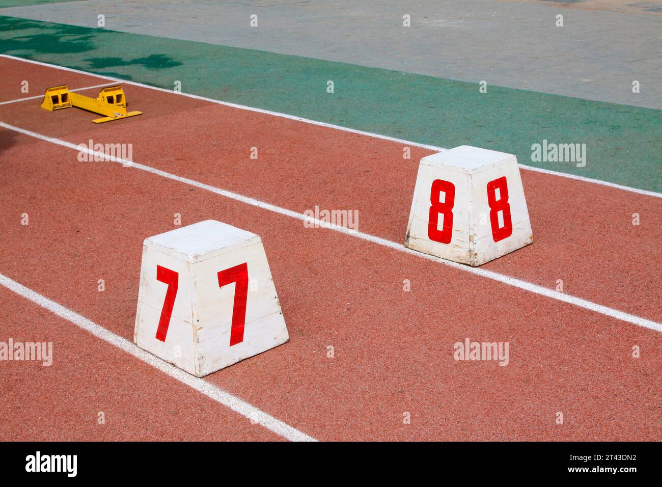 Serial number marked and run up ware on red plastic runway in a sports ...
