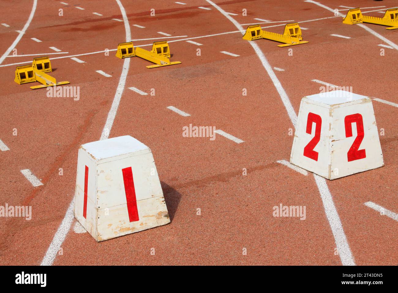 Serial number marked and run up ware on red plastic runway in a sports ...