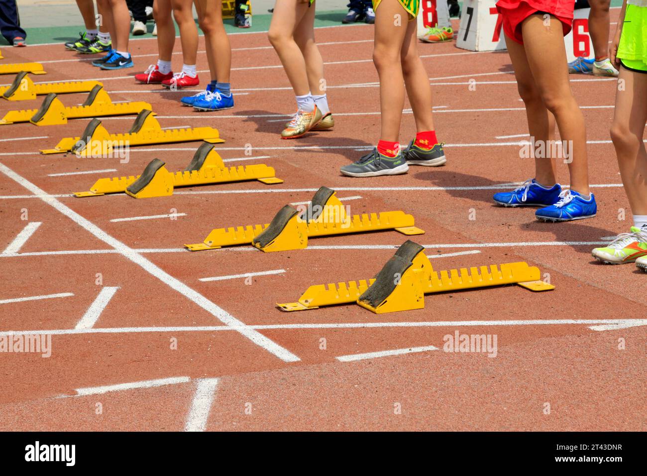 athletes debugging run up ware on plastic runway in a middle school ...