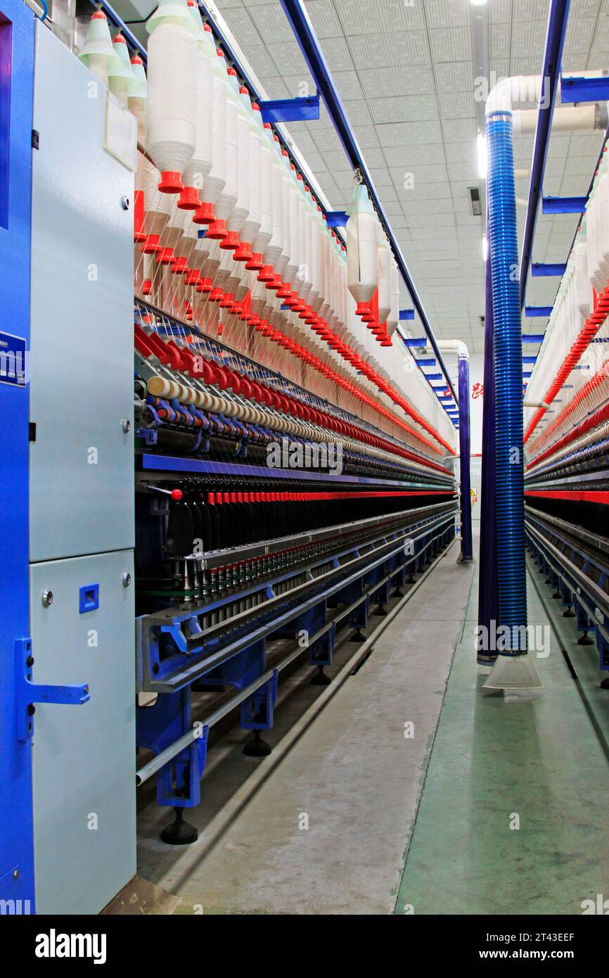 Textile spindles on the production line, closeup of photo Stock Photo ...