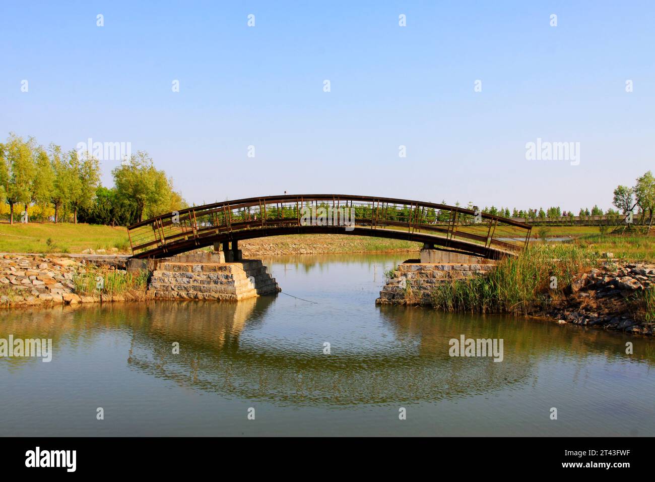 wooden arch bridge in a park, closeup of photo Stock Photo - Alamy