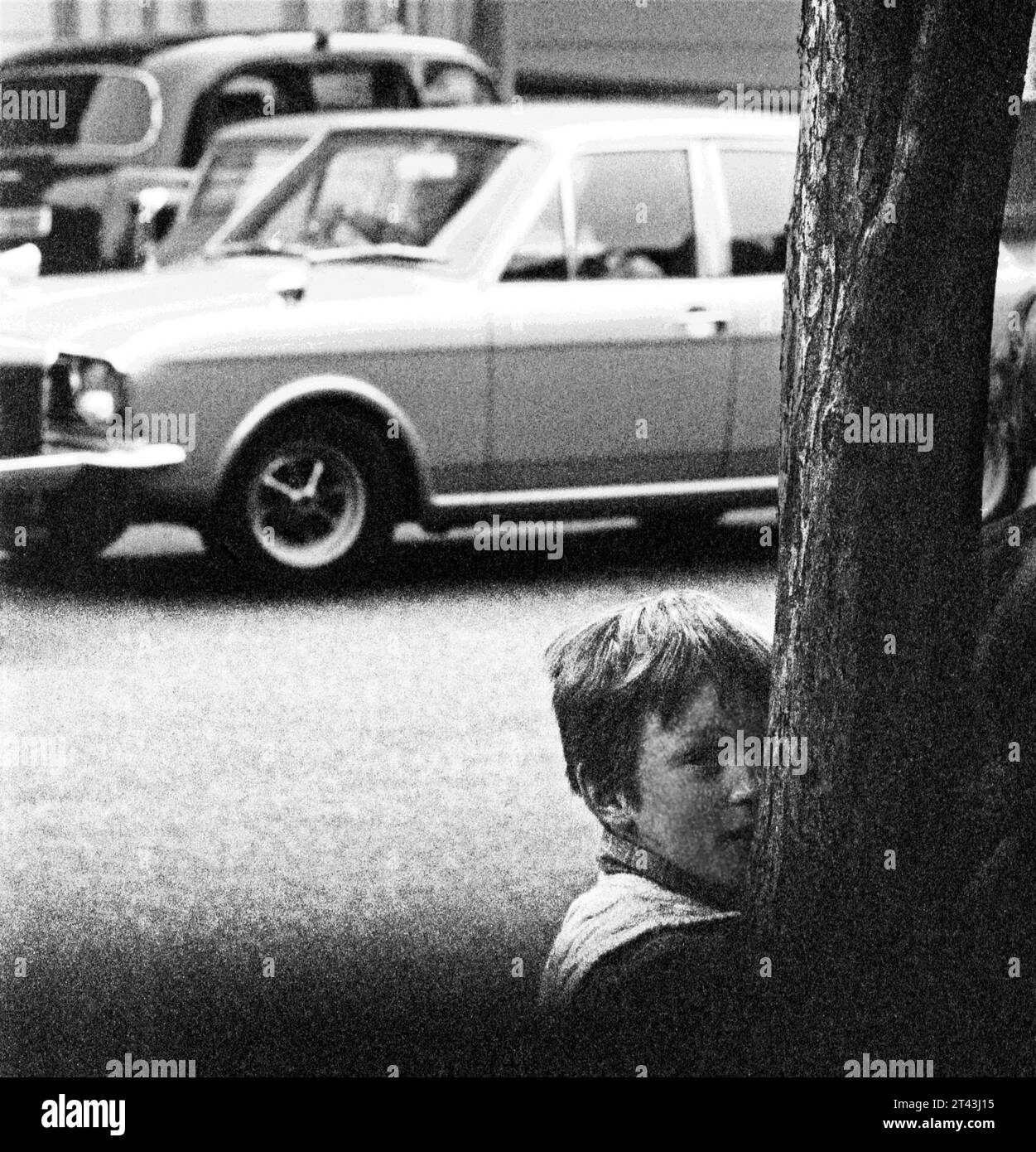 A child peeking behind a tree, London, England, 1971 Stock Photo - Alamy