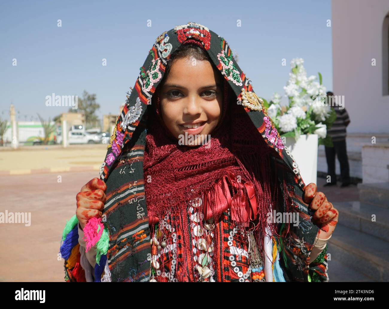A local young girl stands wearing the traditional women's costume of ...