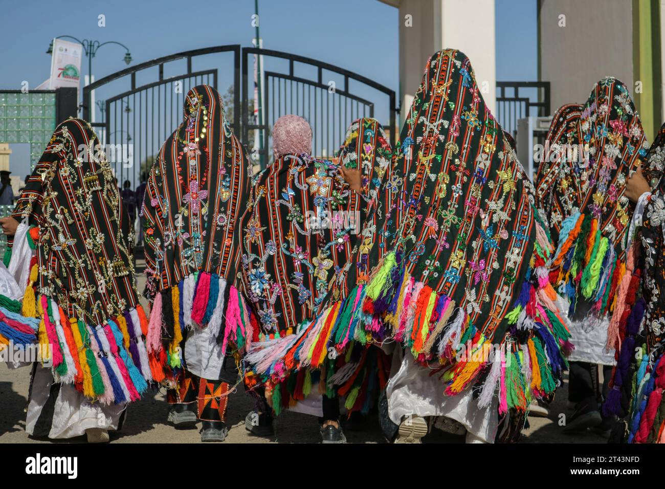 A group of young girls walk wearing the traditional women's costumes of ...