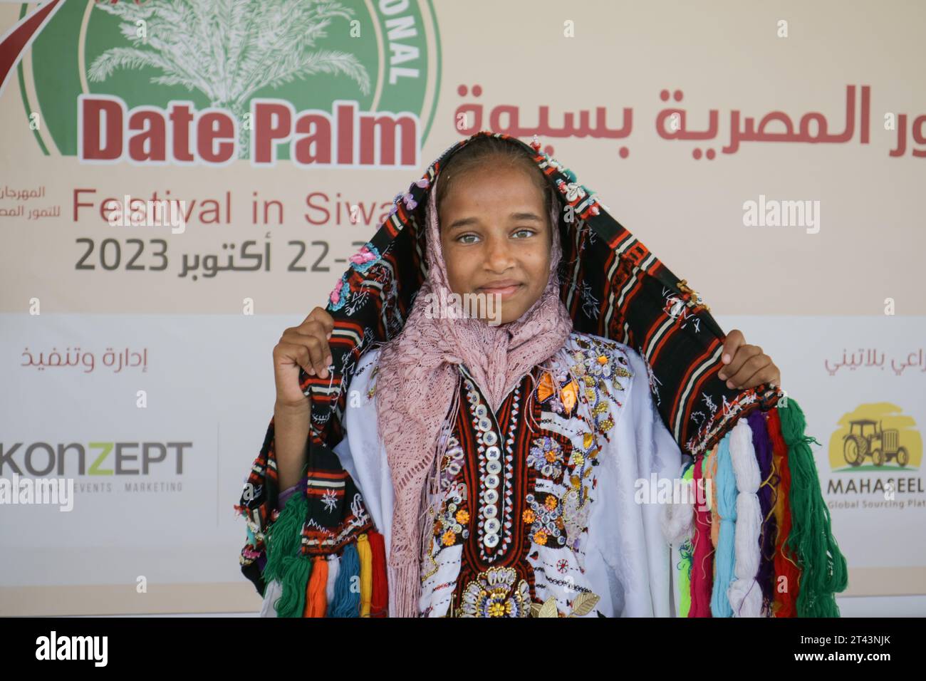 A local young girl stands wearing the traditional women's costume of ...