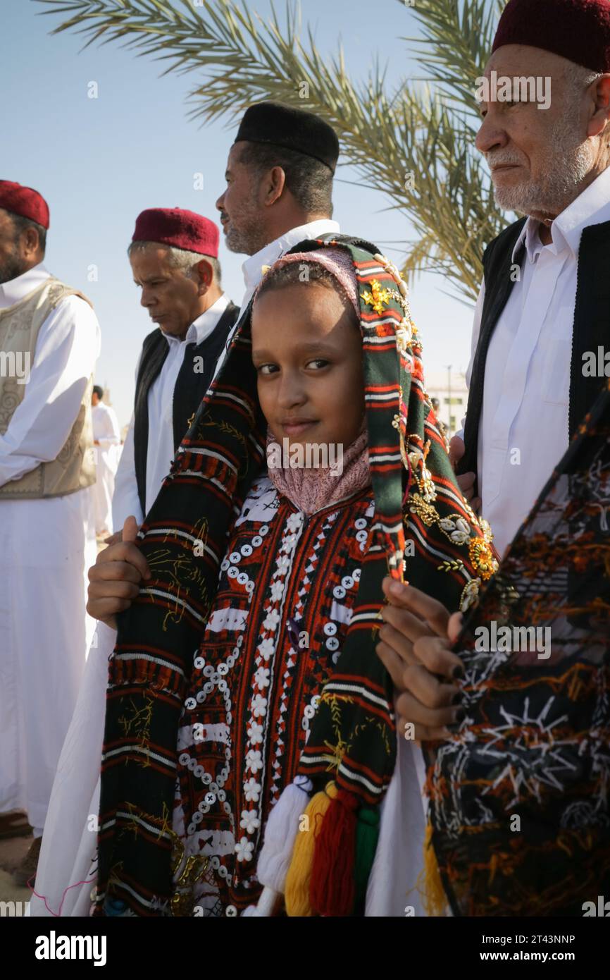 A local young girl stands wearing the traditional women's costume of ...