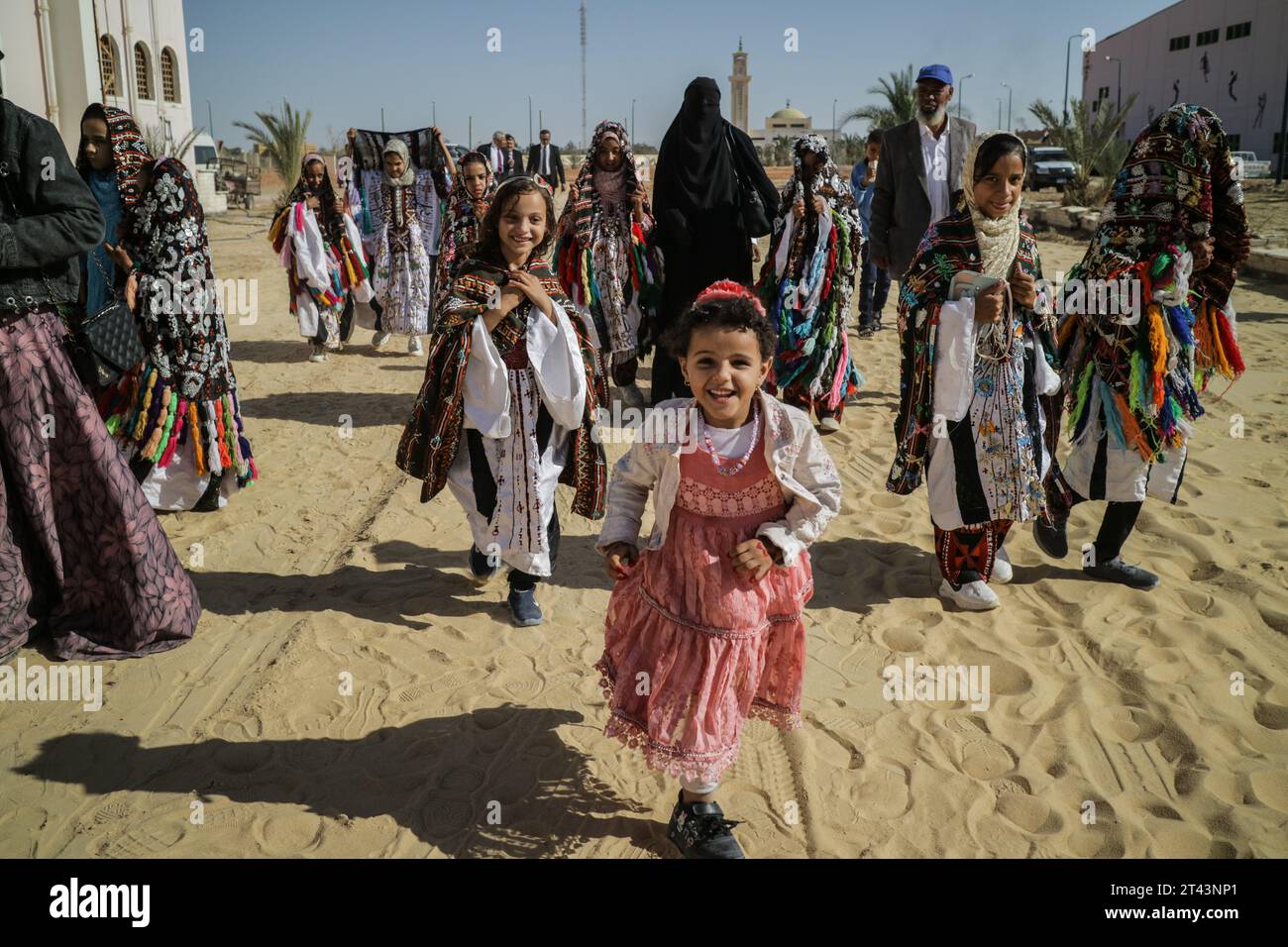 A group of young girls walk wearing the traditional women's costumes of ...