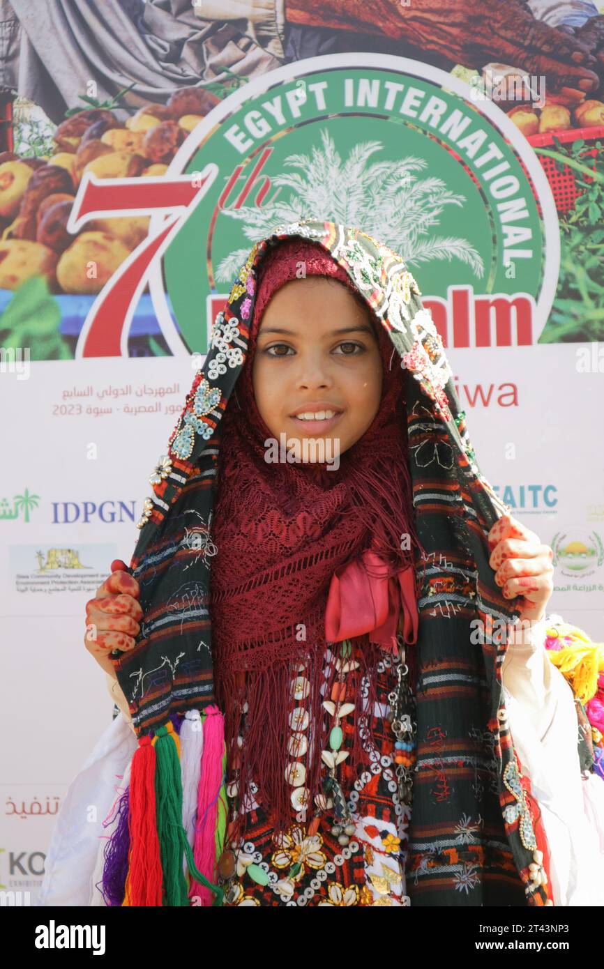 A local young girl stands wearing the traditional women's costume of ...